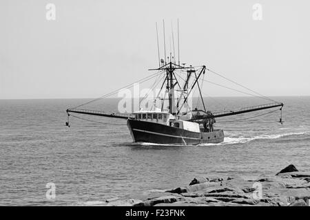A commercial fishing trawler returning from work and about to enter the ...