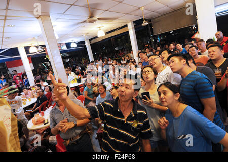 Supporters of ruling party People's Action Party (PAP) wave logo of PAP ...