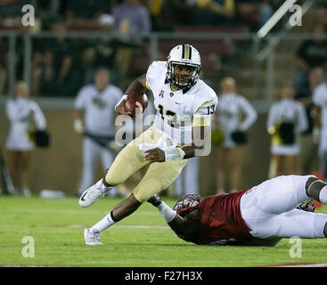 Central Florida quarterback Justin Holman, right, runs from the tackle ...