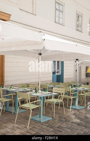 Cafe Tables and Chairs on Cobbled Stones Stock Photo - Alamy