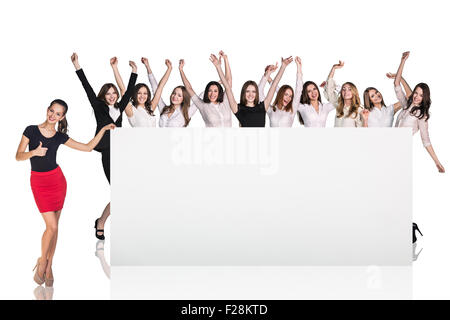Businesswomen near a big placard Stock Photo - Alamy