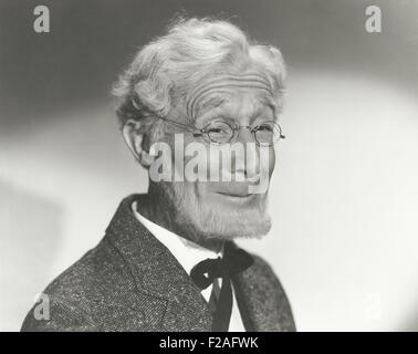 Happy Black man chuckling to himself with a big smile in a close up ...