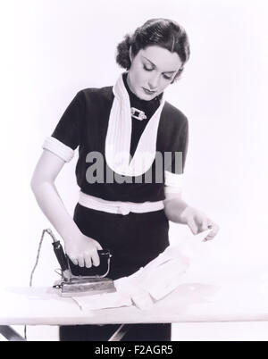 Woman ironing clothes Stock Photo - Alamy