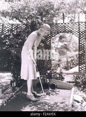 A woman is playing at miniature golf Stock Photo - Alamy