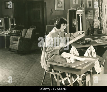 Female artist painting in home office Stock Photo - Alamy