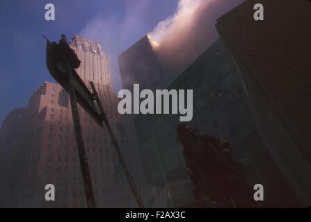 Fire fighter at base of burning WTC 6 following the North Tower (WTC 1 ...