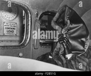 Mae Capone, wife of gangster Al Capone, hides her face from ...