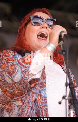 Singing girl holding microphone, performing songs at karaoke, standing ...