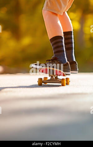 A boy skateboarding outside on a warm summer day Stock Photo - Alamy