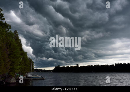 Swirling dark clouds before a thunderstorm over Lake Cecebe in cottage ...