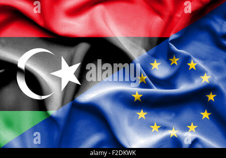 European Union Flag and Libya flag waving with texture sky Cloud and ...