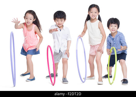 Happy children rolling plastic hoops Stock Photo: 87585412 - Alamy