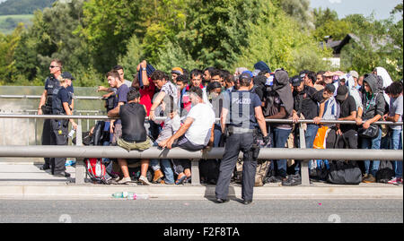 Freilassing, Germany. 17th Sep, 2015. Refugees wait to cross into ...