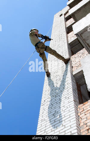 Special forces operator rappelling with weapons during an assault Stock ...