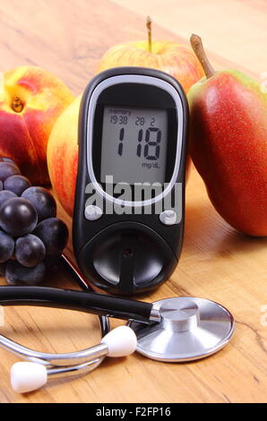 Glucose meter with medical stethoscope and fresh fruits, concept of ...