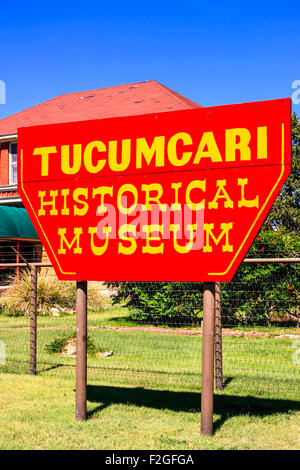 USA, New Mexico, Tucumcari, Red Vintage car drives over Route 66 marker ...