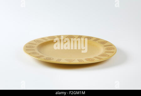 Rustic ceramic plate decorated with symbols on the rim Stock Photo - Alamy