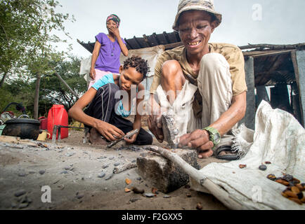 San people, or bushmen cooking food in Botswana, Africa Stock Photo - Alamy