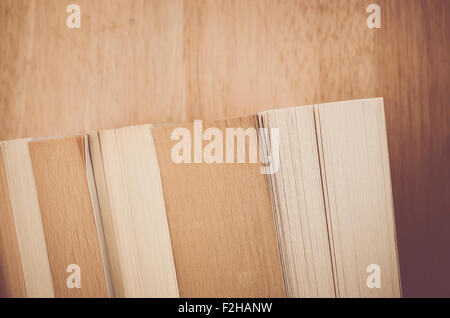 books and manuals lined up on a wooden background - reading and ...