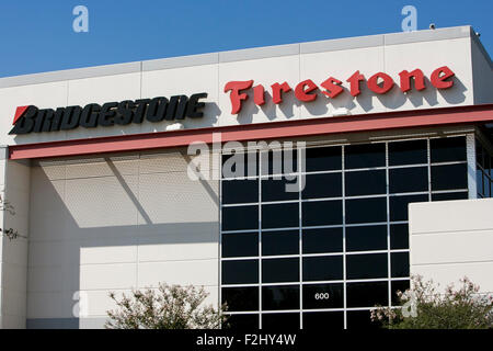 A logo sign outside of the Bridgestone Firestone agricultural tire ...