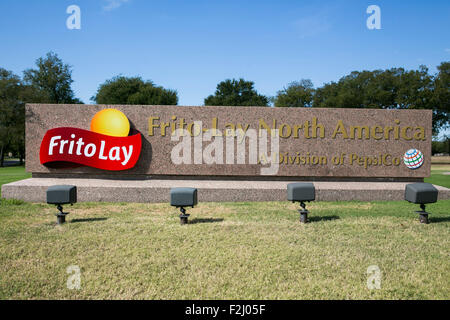 A logo sign outside of the headquarters of Frito-Lay, Inc., a ...