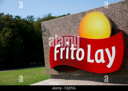 A logo sign outside of the headquarters of Frito-Lay, Inc., a ...