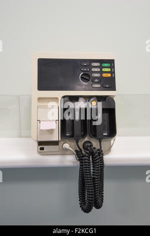 Doctors, defibrillator and machine in surgery in theatre of cardiology ...