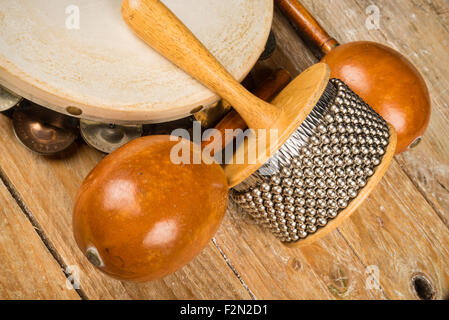 Several small percussion instruments on a rustic wooden surface Stock ...