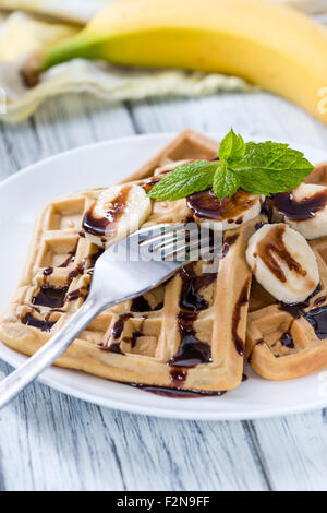 A closeup shot of gourmet waffles with chocolate, icecream, and ...