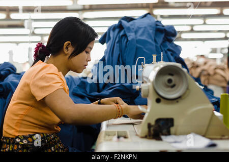Asian worker sewing clothing in garment factory Stock Photo - Alamy