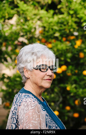 A older senior citizen woman standing isolated for white background in ...