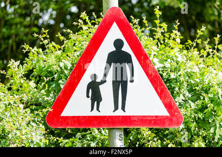 Red triangle road sign parent and child Stock Photo - Alamy