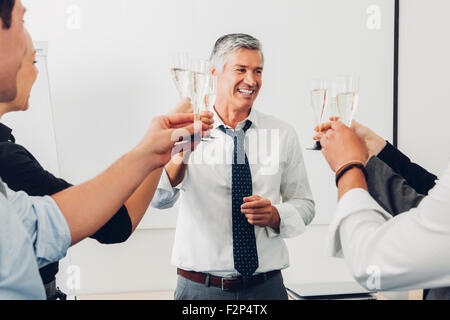 Group of business people raising a toast with champagne at office Stock ...