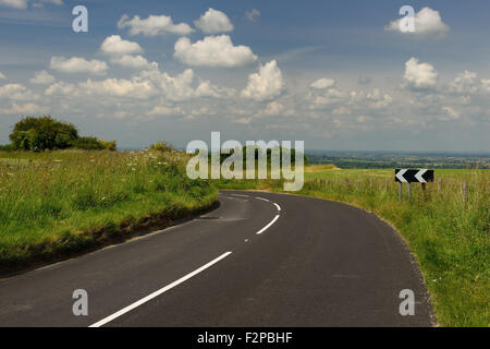 Country road approaching sharp bend and steep gradient Stock Photo ...