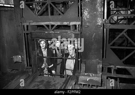 Miners emerging in the cage after completing a shift on the coal face ...