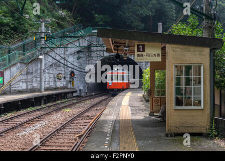 A Hakone Tozan line train comes out of the tunnel mouth at Tonosawa ...