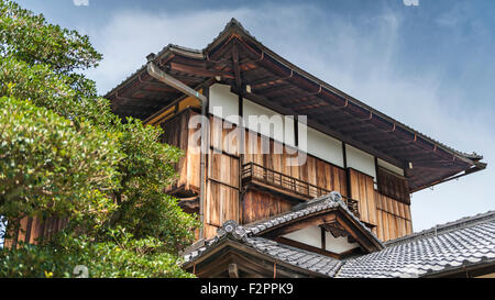 Traditional Japanese ornate wooden roof overhang with gold decoration ...