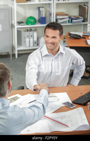 Hand shake of businessmen on corporate building background Stock Photo ...