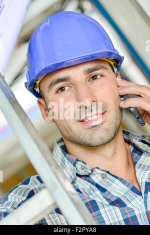 male tradesman making telephone call Stock Photo - Alamy