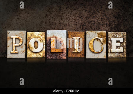 The word "POLICE" written in rusty metal letterpress type isolated on a ...