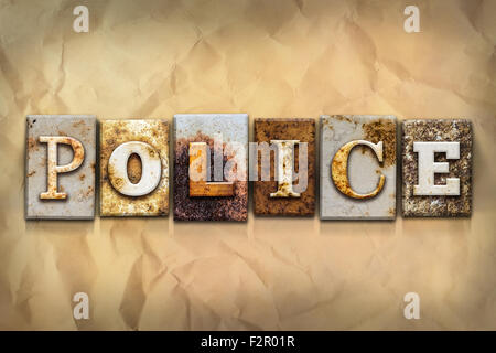 The word "POLICE" written in rusty metal letterpress type isolated on a ...