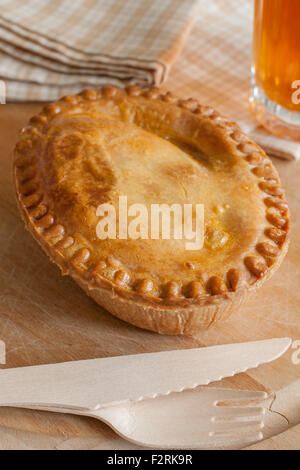 Australian meat pie on wooden table close-up with copy space, rustic ...