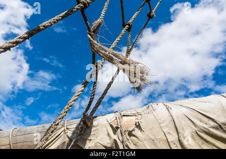 Old ragged sailing rigging an ancient sailing vessel against cloudy sky ...