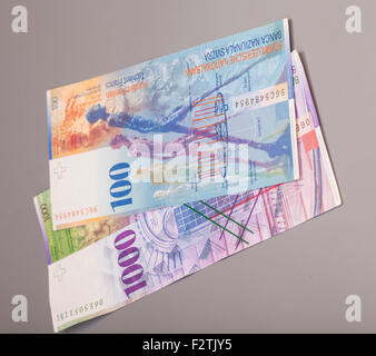 Swiss 1000 and 100 Franc notes isolated on gray Stock Photo - Alamy