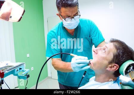 Mending patient's teeth Stock Photo - Alamy