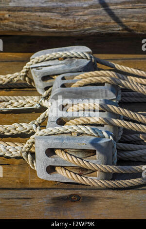 rigging blocks,wooden,ropes, rigging, on shore for repairs,worn ...