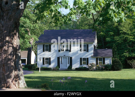 Exterior of white clapboard house with black shutters Stock Photo - Alamy