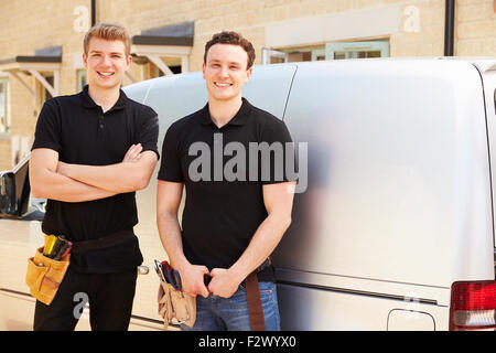 Portrait of two young tradesmen by their van Stock Photo - Alamy