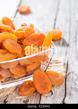 Dried fruits. Dried apricots and raw apricots on a gray stone ...