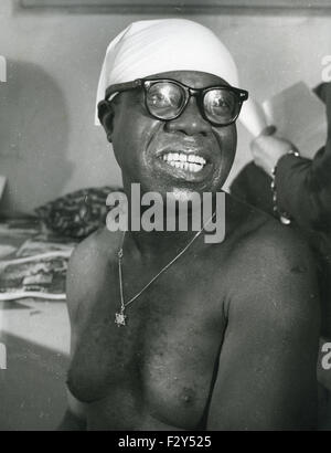 LOUIS ARMSTRONG (1901-1971) US jazz musician is presented with a ...